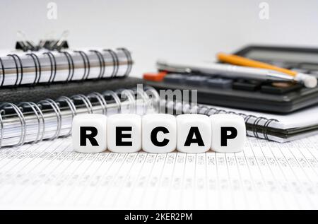 Recap symbol. The word 'recap' on wooden cubes on beautiful grey ...
