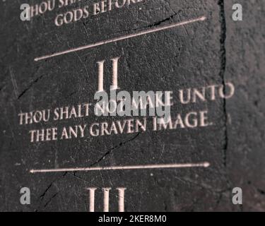 Two cracked stone tablets with the ten commandments etched into them ...