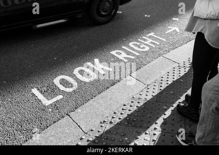 Iconic 'look right' painted road marking for pedestrians in London with ...