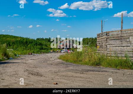 Tractor picking up garbage at a public dump. Industrial waste. Garbage ...