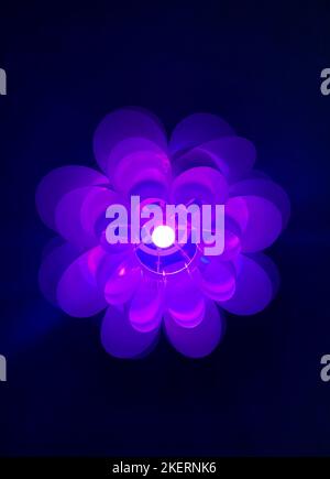 Modern ultraviolet lamp glowing on black background Stock Photo - Alamy