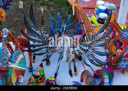 Brightly painted alebrijes carved of copal wood representing real and ...