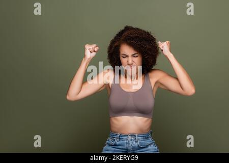 Image of attractive irritated woman with curly red hair shouting and ...