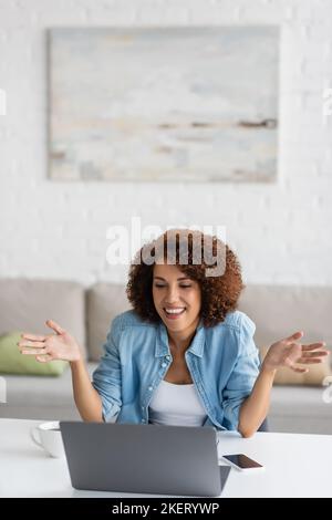 Cheerful woman gesturing call me stock photo Stock Photo - Alamy