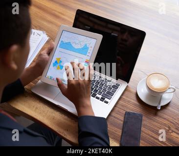 Close-up shot of unrecognizable financial manager sitting at wooden ...