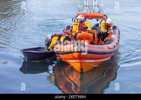 RNLI RIB and Crew Rescuing small boat Stock Photo - Alamy