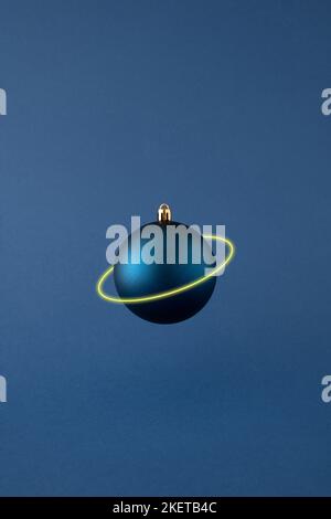 Blue Christmas bauble levitating isolated on blue background. Minimal ...