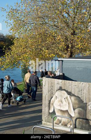 diners and strollers in winter beside the river thames in kingston ...