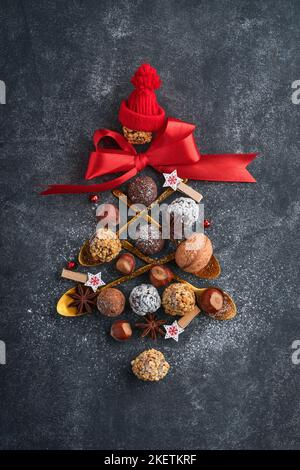 Christmas tree made of chocolate truffles, hazelnuts, anise stars ...