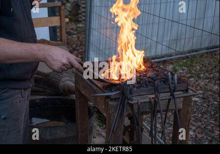 A forge where a hot iron rod is struck Stock Photo - Alamy
