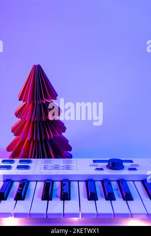 Christmas background with midi keyboard and holiday decor with neon ...