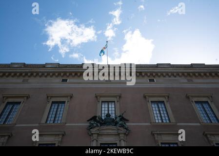 Sweden Flag flying above The Royal Palace, on a sunny day, with a guard ...