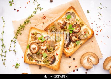 Tasty toasts with cream cheese and mushrooms on beige background ...