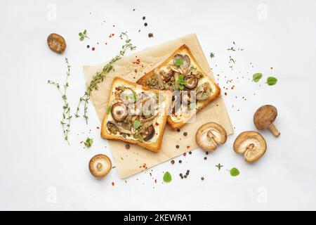 Tasty toasts with cream cheese and mushrooms on beige background ...