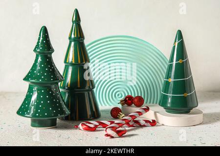 Decorative Christmas trees with podiums, candy cane and balls on blue ...