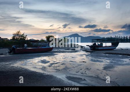sunset scene of the fishing boats harbored at the seaside Stock Photo ...