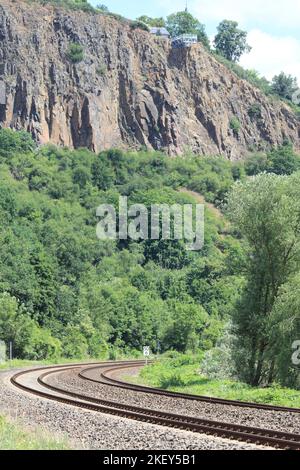 Railroad tracks lead through a natural landscape Stock Photo - Alamy