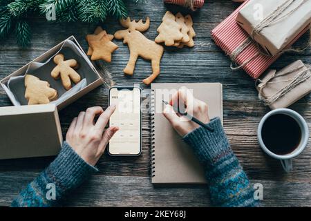 Woman making to-do list for year 2023 on light blue background, top ...