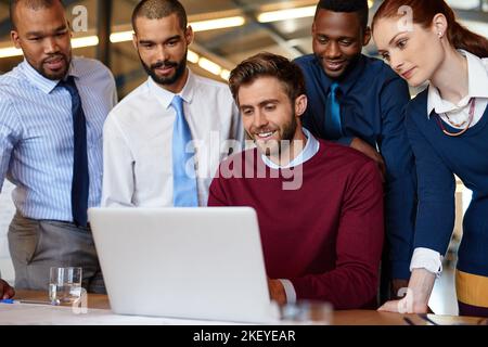 Getting it done through teamwork. a group of businesspeople in the ...