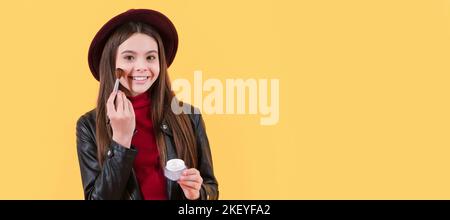 Happy kid apply cosmetics with powder brush yellow background, makeup ...