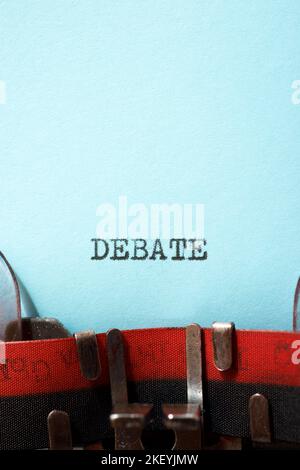 Debate word written with a typewriter Stock Photo - Alamy