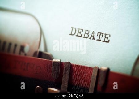 Debate word written with a typewriter Stock Photo - Alamy