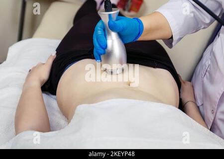 Radio frequency tummy tuck. Anti-cellulite massage with cavitation and ...