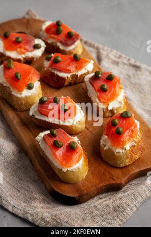 Homemade Lox And Cream Cheese Crostini on a wooden board, top view ...