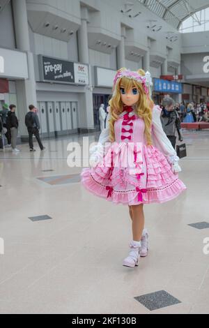 Happy girl in face mask posing with fingers crossed for good luck ...