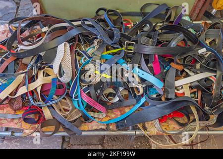 Bunch of used belts at flea market Stock Photo - Alamy