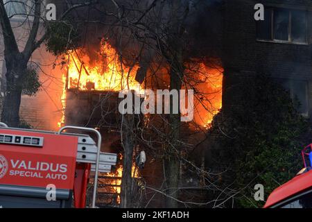 A fire is seen at a residential building hit by a Russian strike amid ...