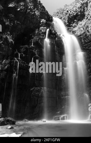 a Vertical light exposure grayscale shot of a waterfall Stock Photo - Alamy