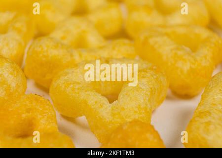 Delicious crispy corn chips triangular shape with spices on a black ...