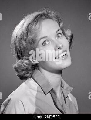 Facial expression of admiring blonde woman looking at camera, raised ...