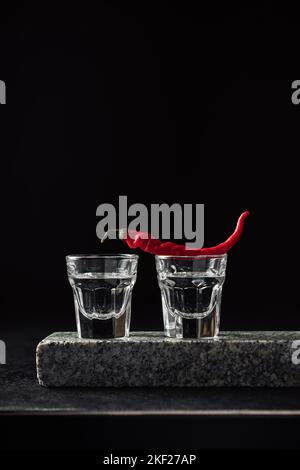 Two shots of vodka with red hot pepper Stock Photo - Alamy
