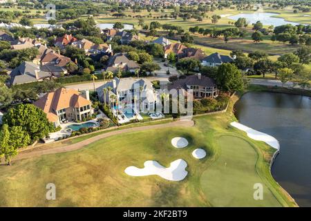 Aerial overview of luxury villas located around green zone and golf ...
