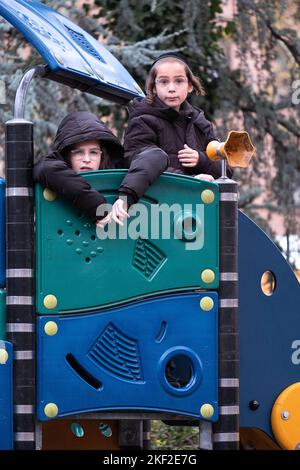 During recess, 2 orthodox Jewish students with long peyes play Cat's ...