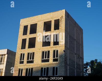 Unfinished concrete five-story residential building without windows ...
