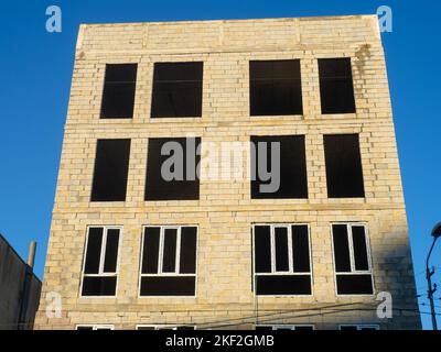 Unfinished concrete five-story residential building without windows ...