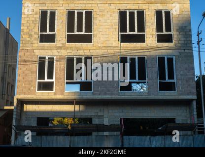 Unfinished concrete five-story residential building without windows ...
