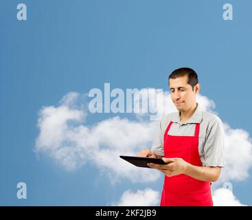 Cropped image of man holding tablet computer while studying with ...