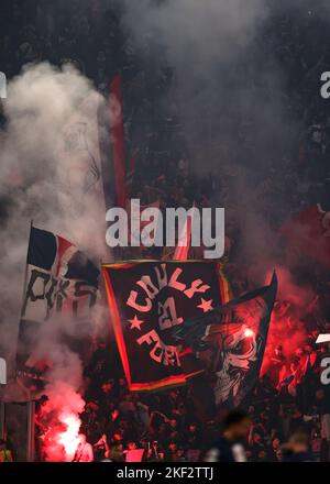 PSG supporters wave team flags during a parade in front of the Arc de ...
