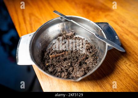 conducting a soil test in a home lab. soil on a table. brown dirt in a ...