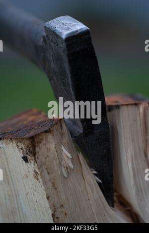 An axe cutting through log Stock Photo - Alamy