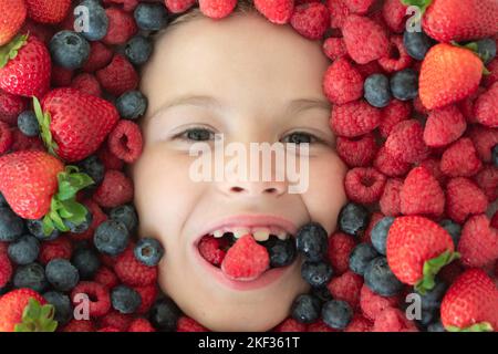 Child picking raspberry. Kids pick fresh fruit on organic raspberries ...