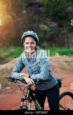 Adventurous mountain biker riding his bike fast through the woods ...