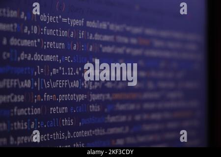 Simple website HTML code with colorful tags in browser view on dark background. Software ...