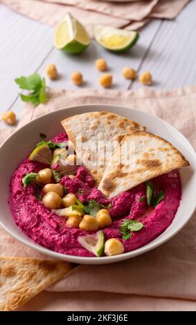 Close-up of Beetroot hummus on white table Stock Photo - Alamy