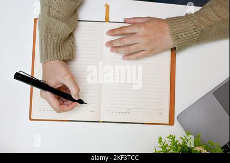 cropped view of freelancer taking paper napkin from pack near devices ...