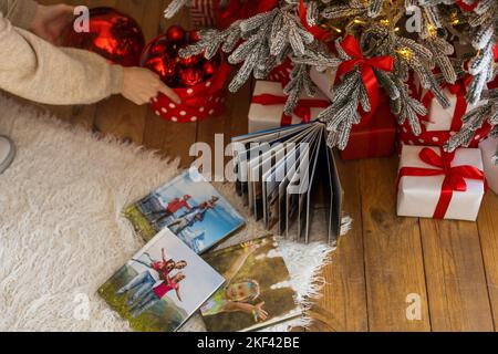 Photo book album under the Christmas tree surrounded by Christmas gifts ...